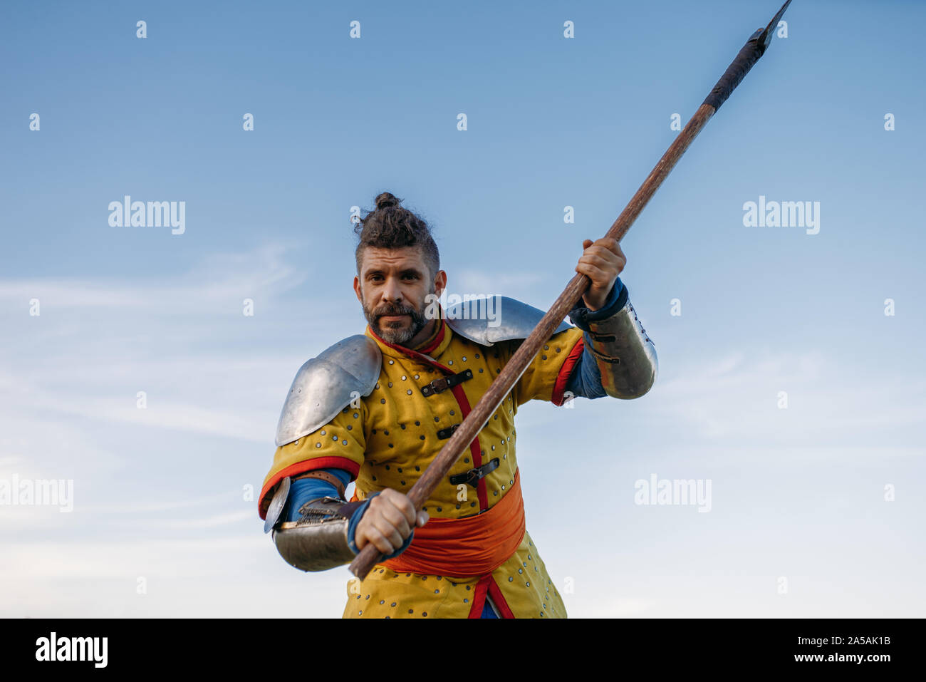 Old medieval knight in armor holds axe Stock Photo - Alamy