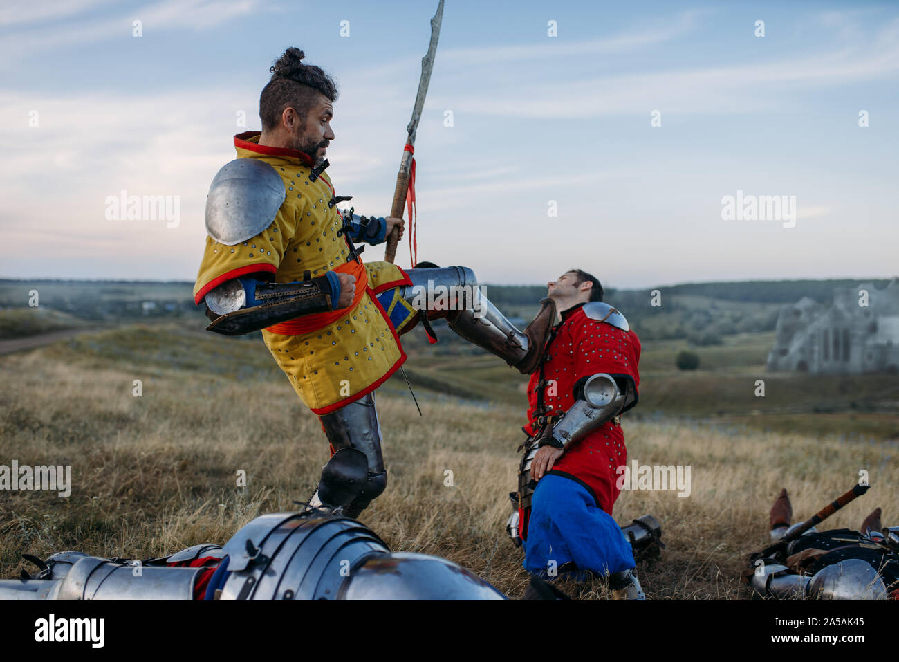 Medieval knight in armor prepares to cut off head Stock Photo - Alamy