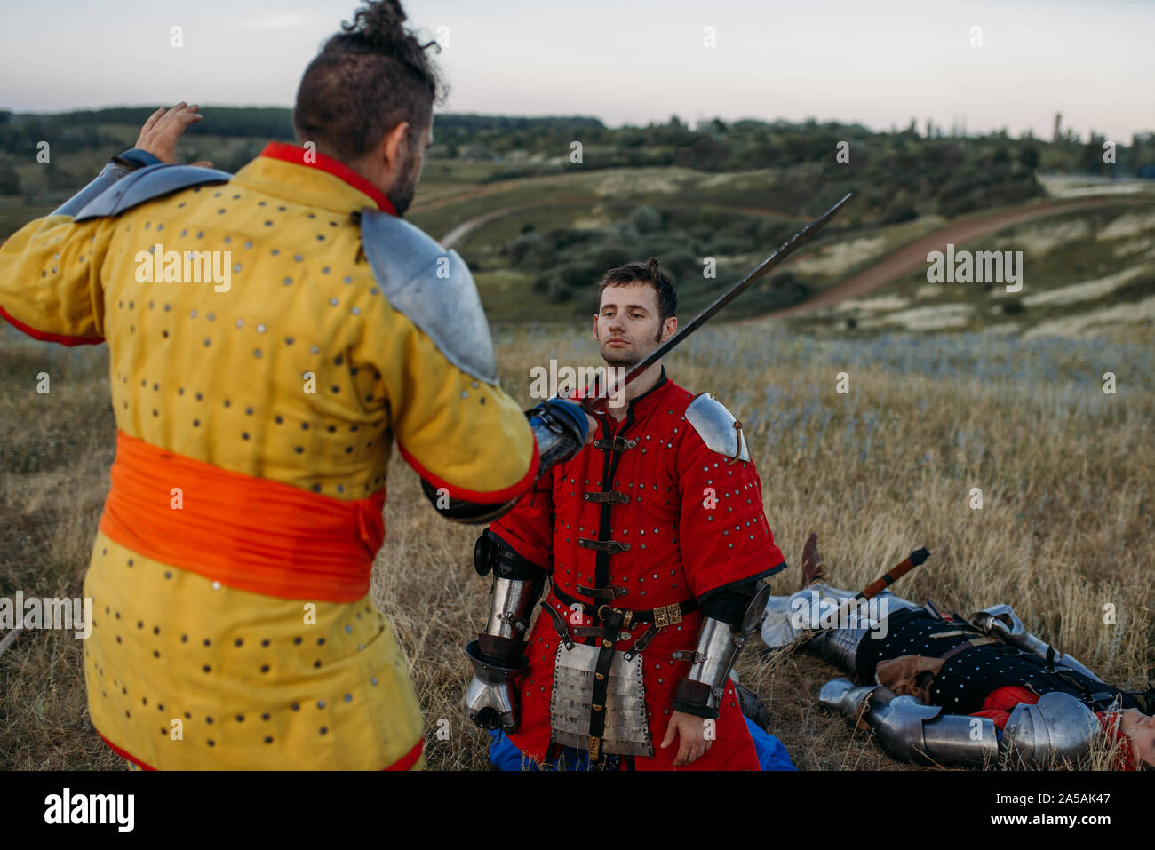 Medieval knight in armor prepares to cut off head Stock Photo - Alamy