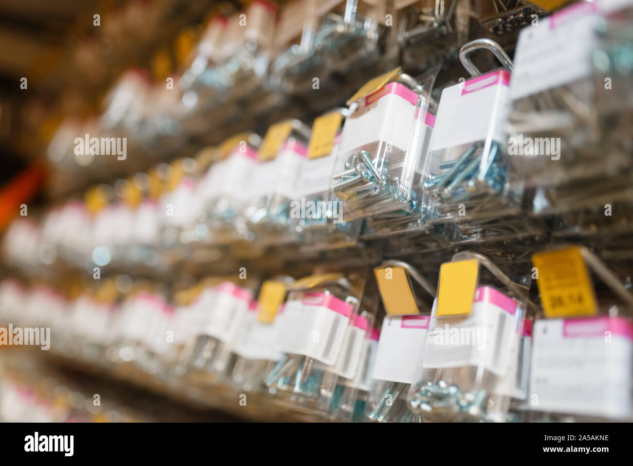 Rows of boxes with bolts in hardware store closeup Stock Photo - Alamy