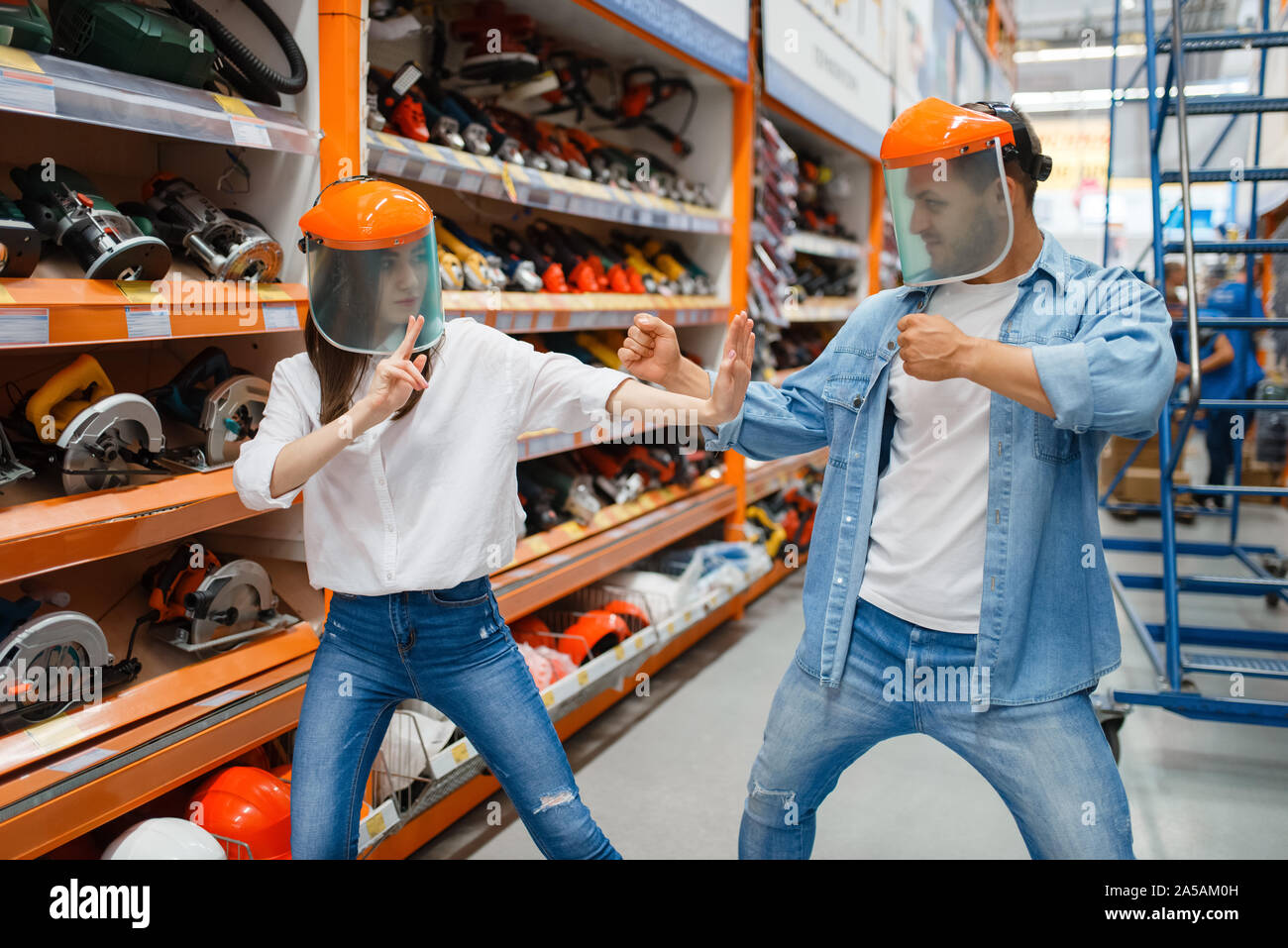 Playful couple fight in hardware store Stock Photo - Alamy