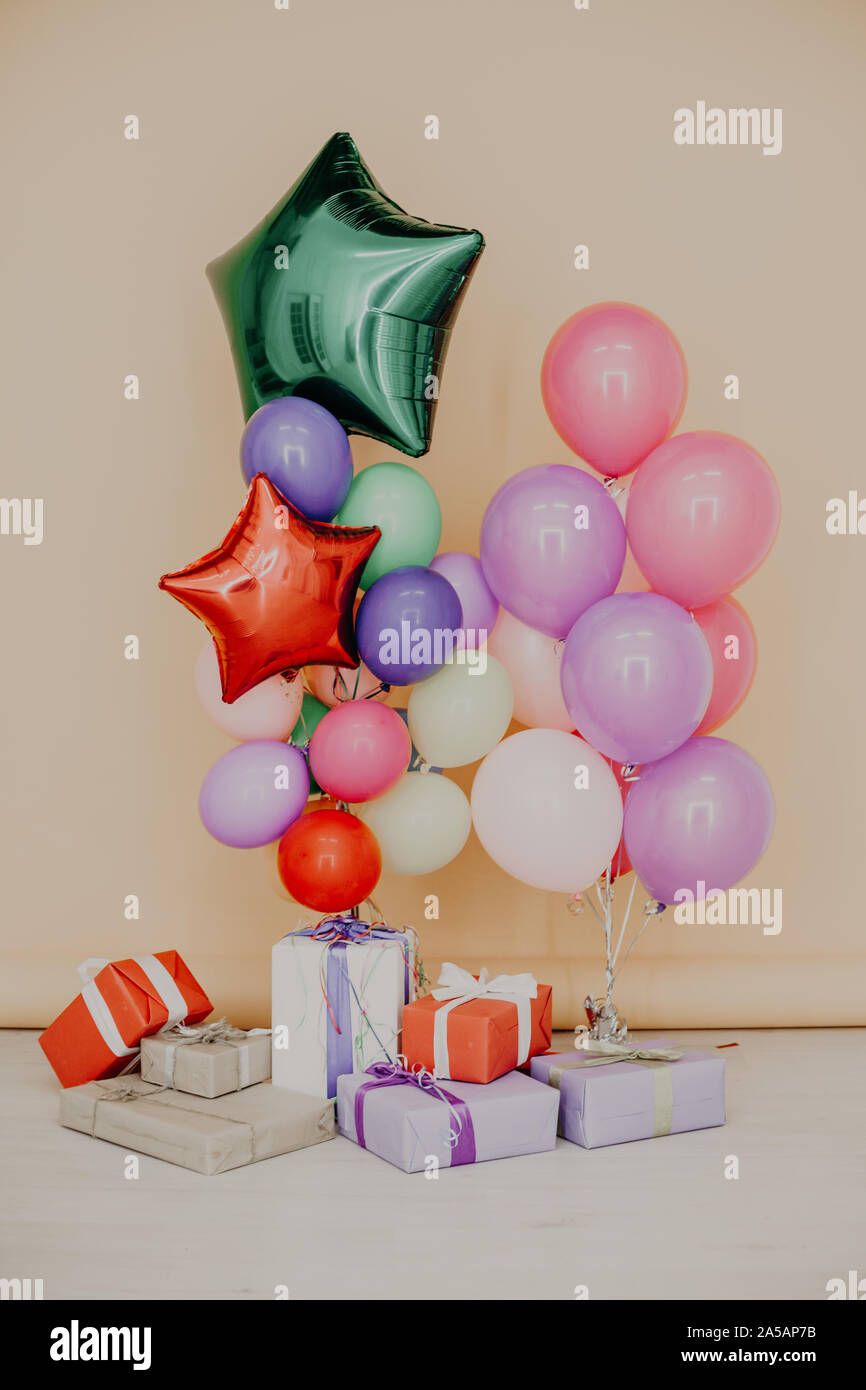 balloons of different colors with gifts for the holiday Stock Photo - Alamy