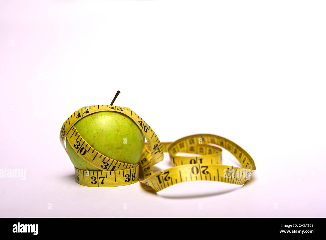 Green Apple with measuring tape isolated on white background Stock ...