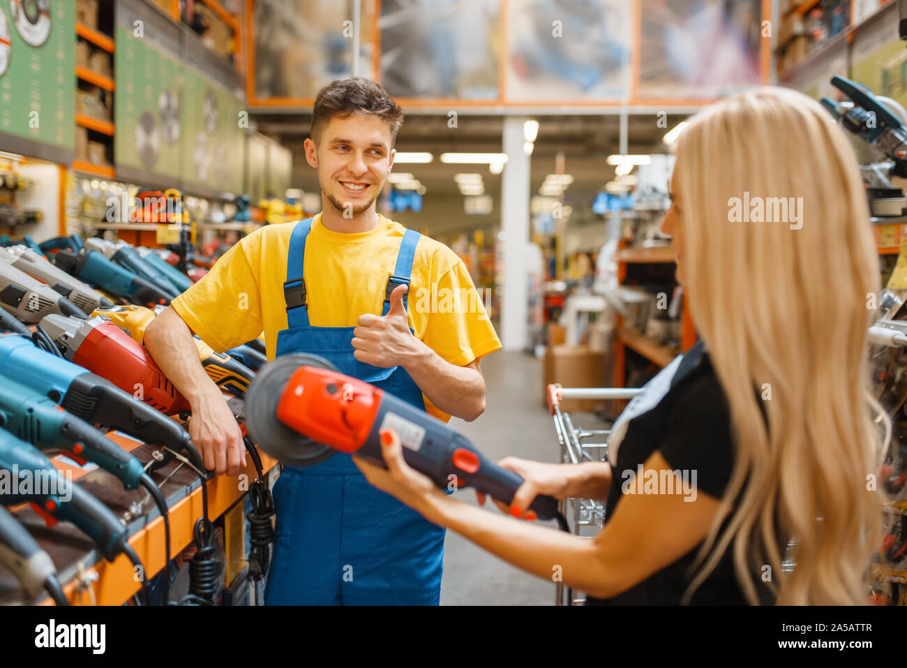 Assistant and female purchaser in hardware store Stock Photo - Alamy