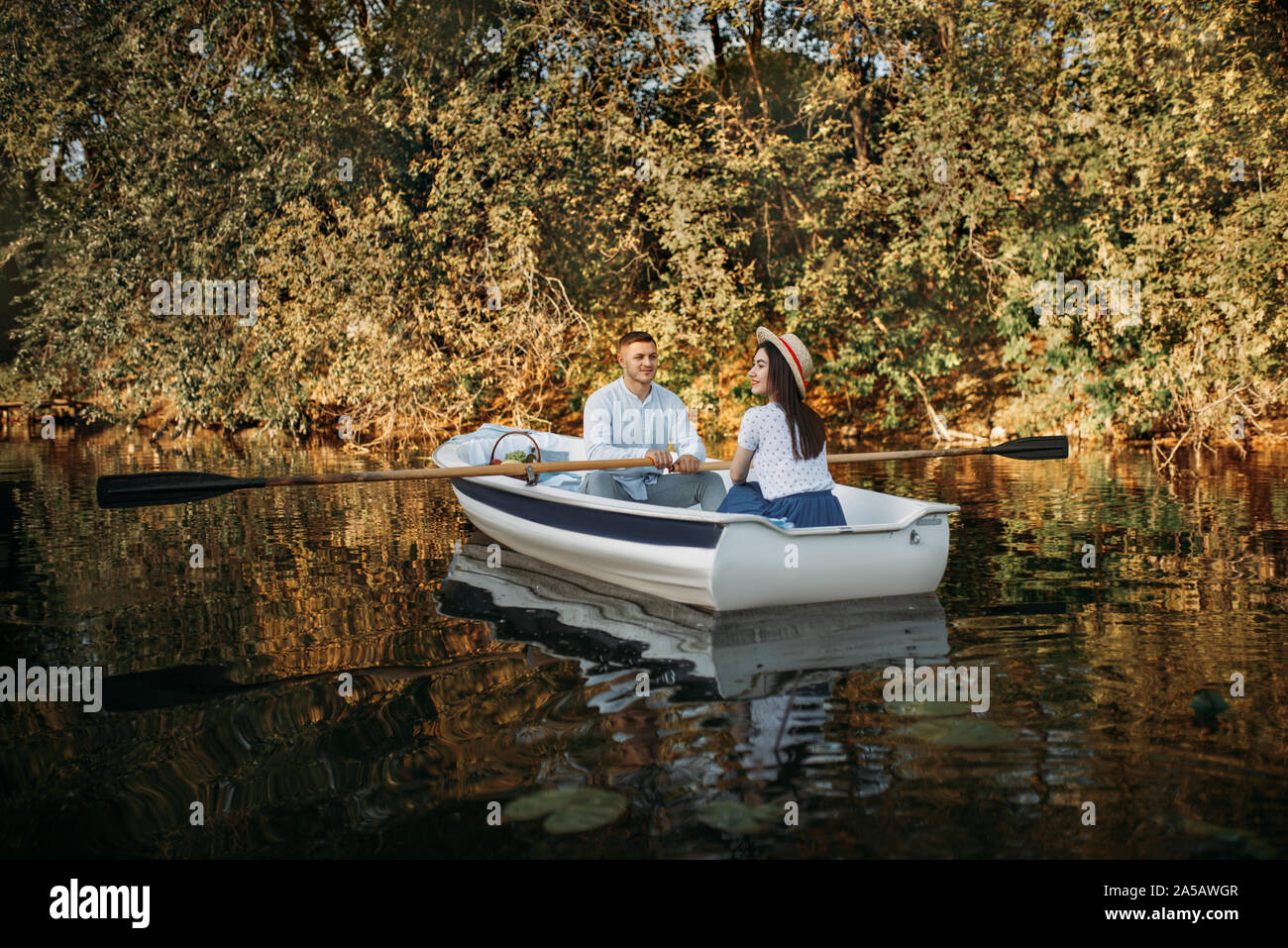 Love couple boating on lake, water reflection Stock Photo - Alamy