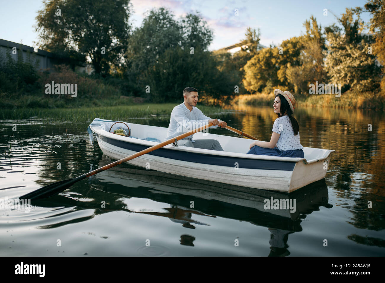 Love couple boating on lake, water reflection Stock Photo - Alamy