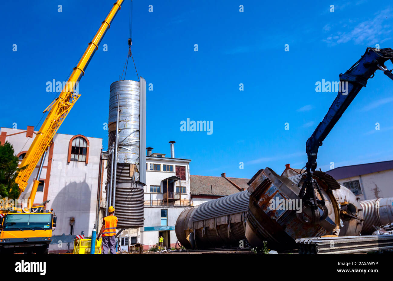 Loader machine with hydraulic grappling claw and crane are bringing ...