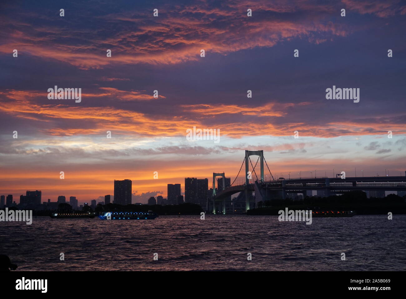 tokyo japan rainbow bridge sun colorful sky Stock Photo - Alamy