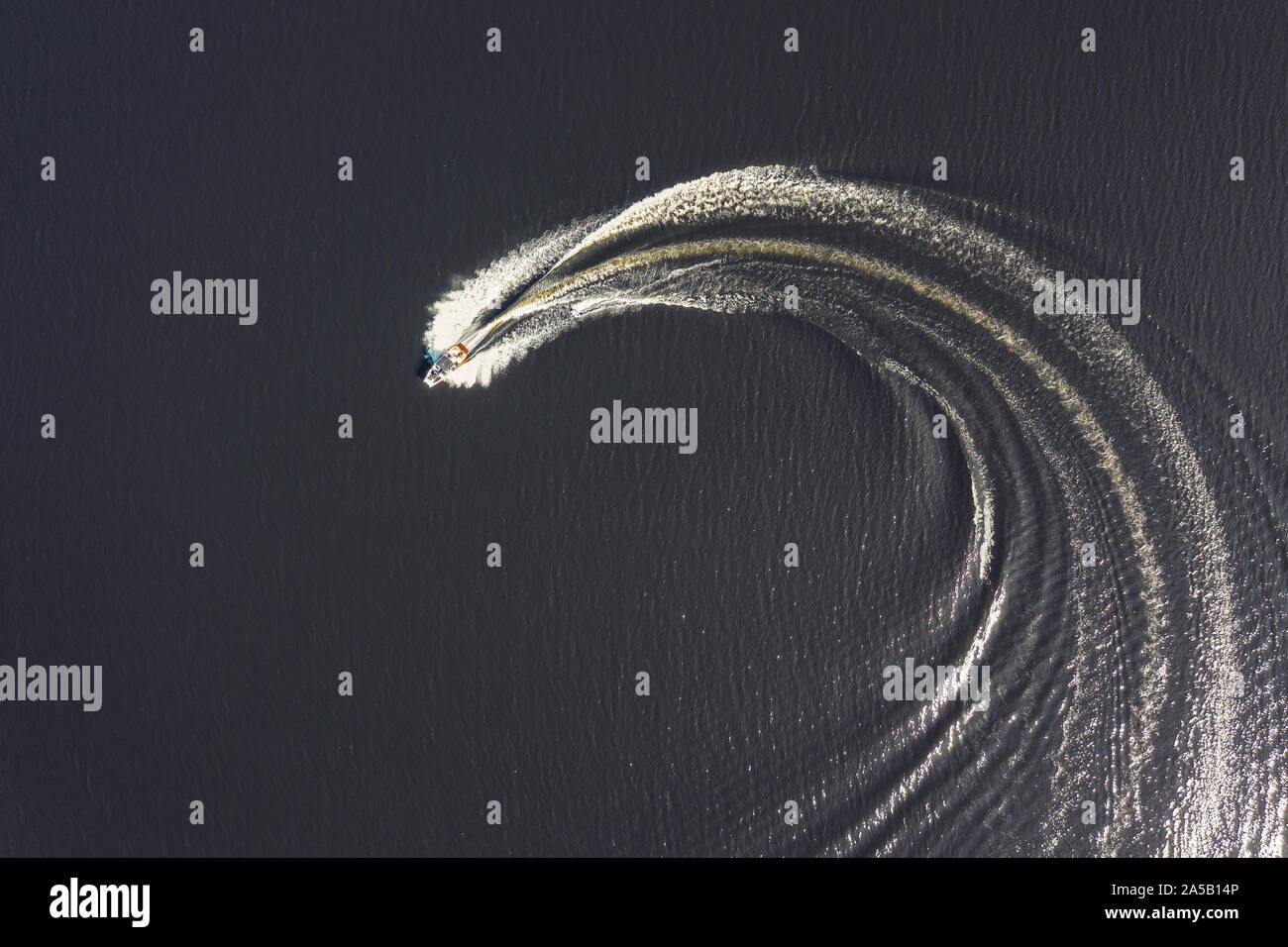 Aerial overhead shot of a small motor boat turning, taken in May 2019 ...