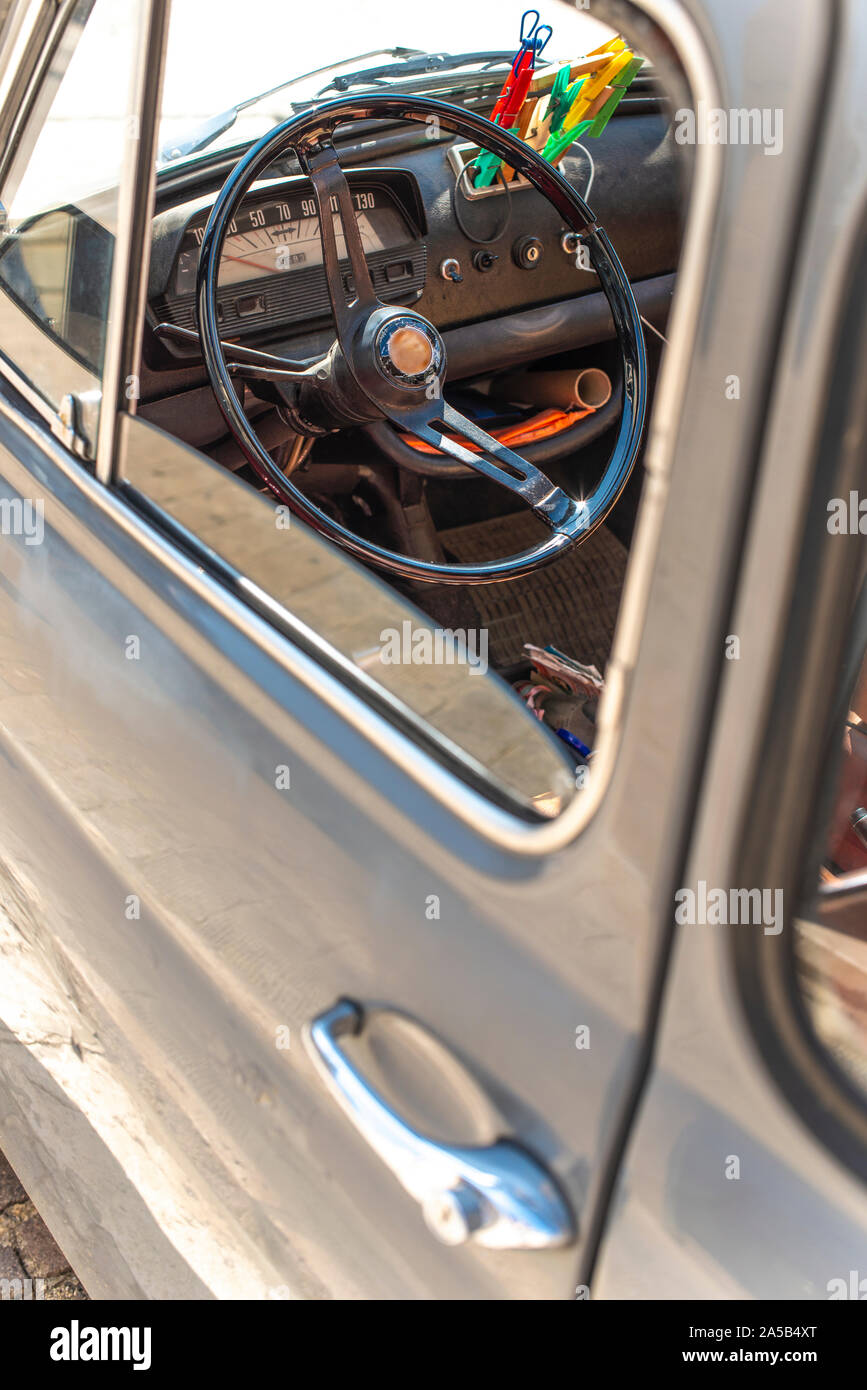 Steering wheel on vintage car. View from the door window. Opened window ...