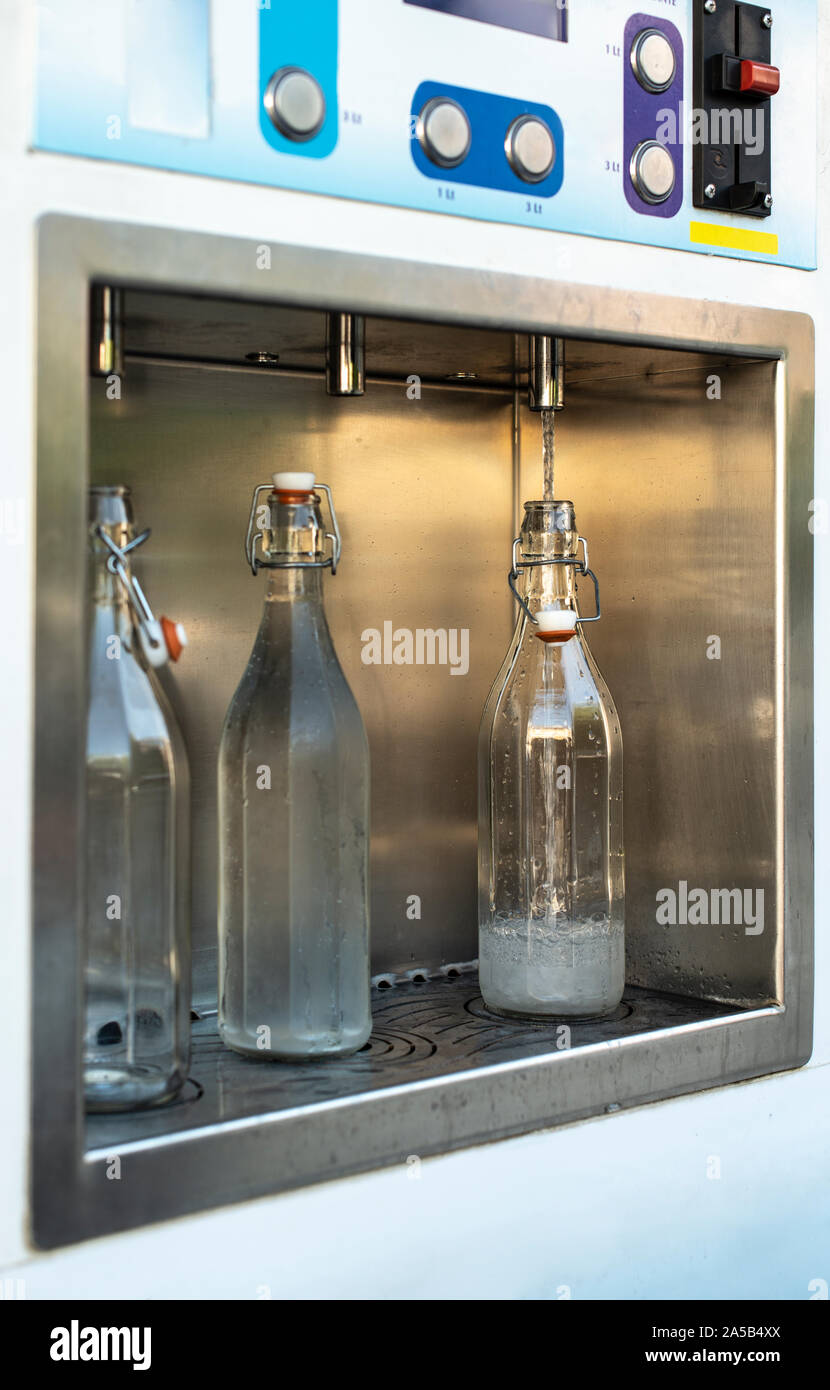 Mineral Water machine on the street. Filling mineral water bottles from ...
