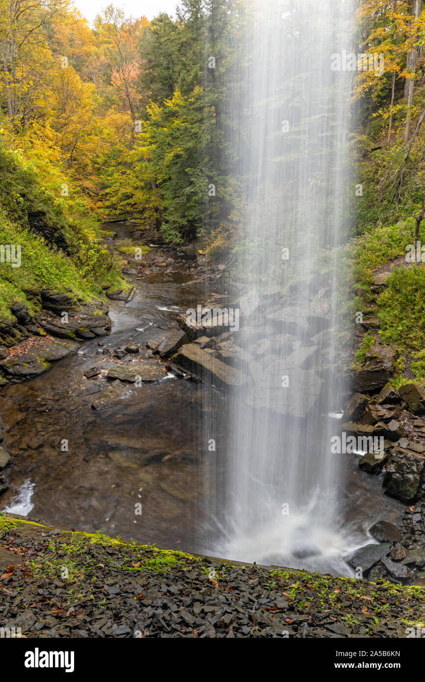 Carpenter Falls seen from the cavern behind surrounded by a quiet ...