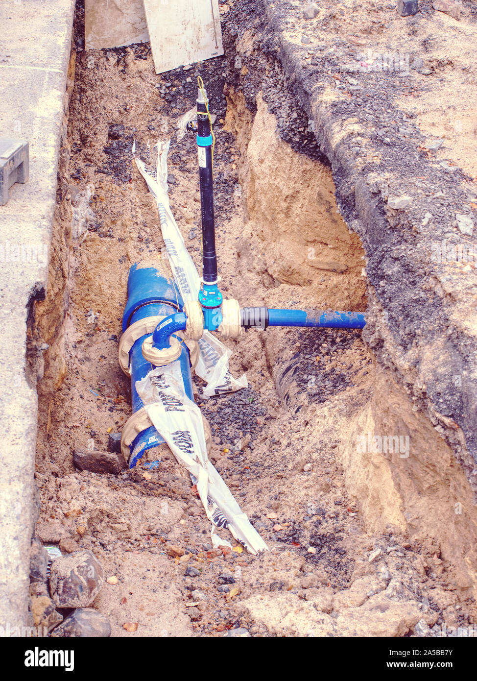 Blue water pipes and shut-off valve on 300mm pipe with plastic tube ...