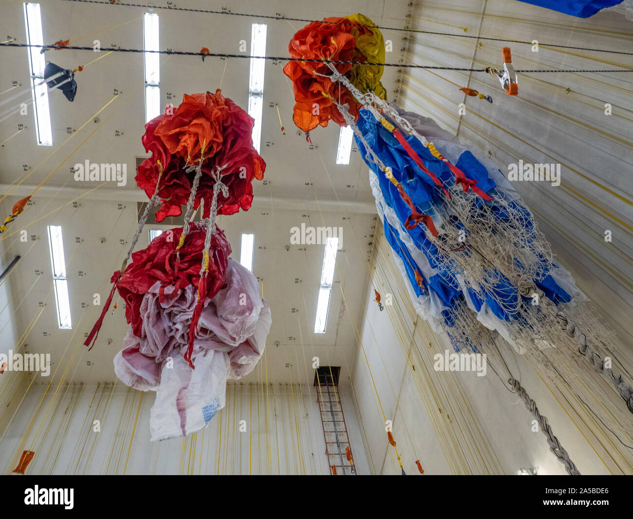 Parachutes hanging from ceiling after being checked and waiting for ...