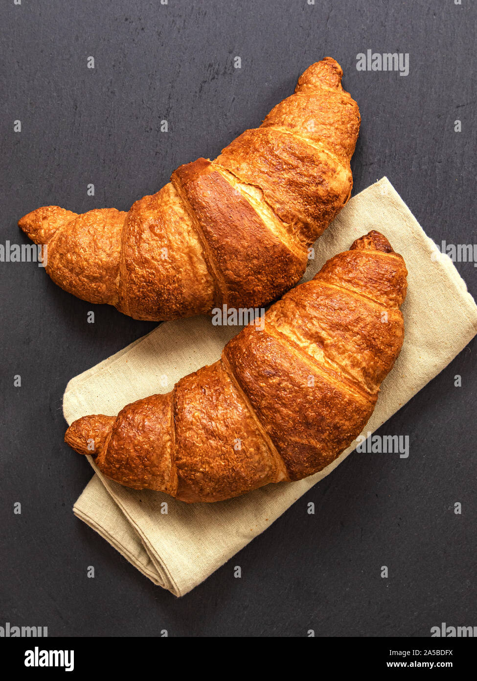Croissants on grey slate background. Vertical image, top view Stock ...