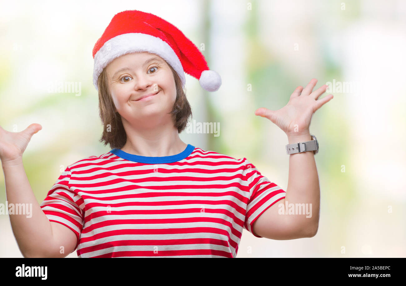 Young adult woman with down syndrome wearing christmas hat over ...