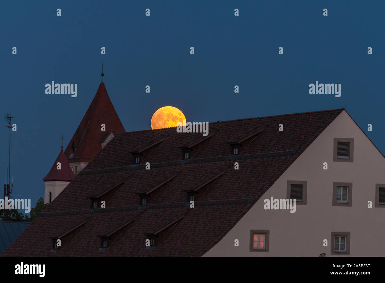Full moon over the roofs and towers of Regensburg, Germany Stock Photo ...