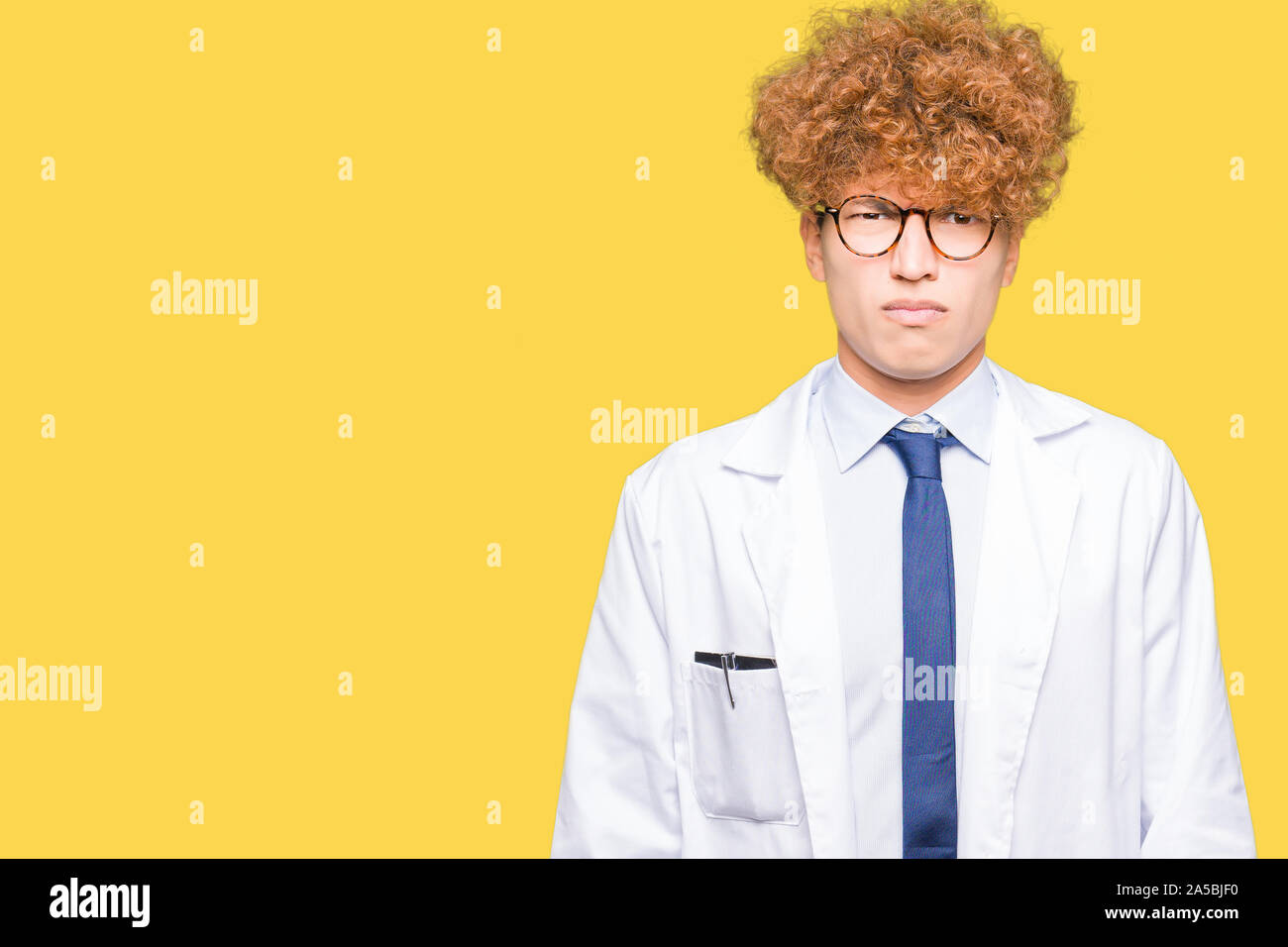 Young handsome scientist man wearing glasses skeptic and nervous ...