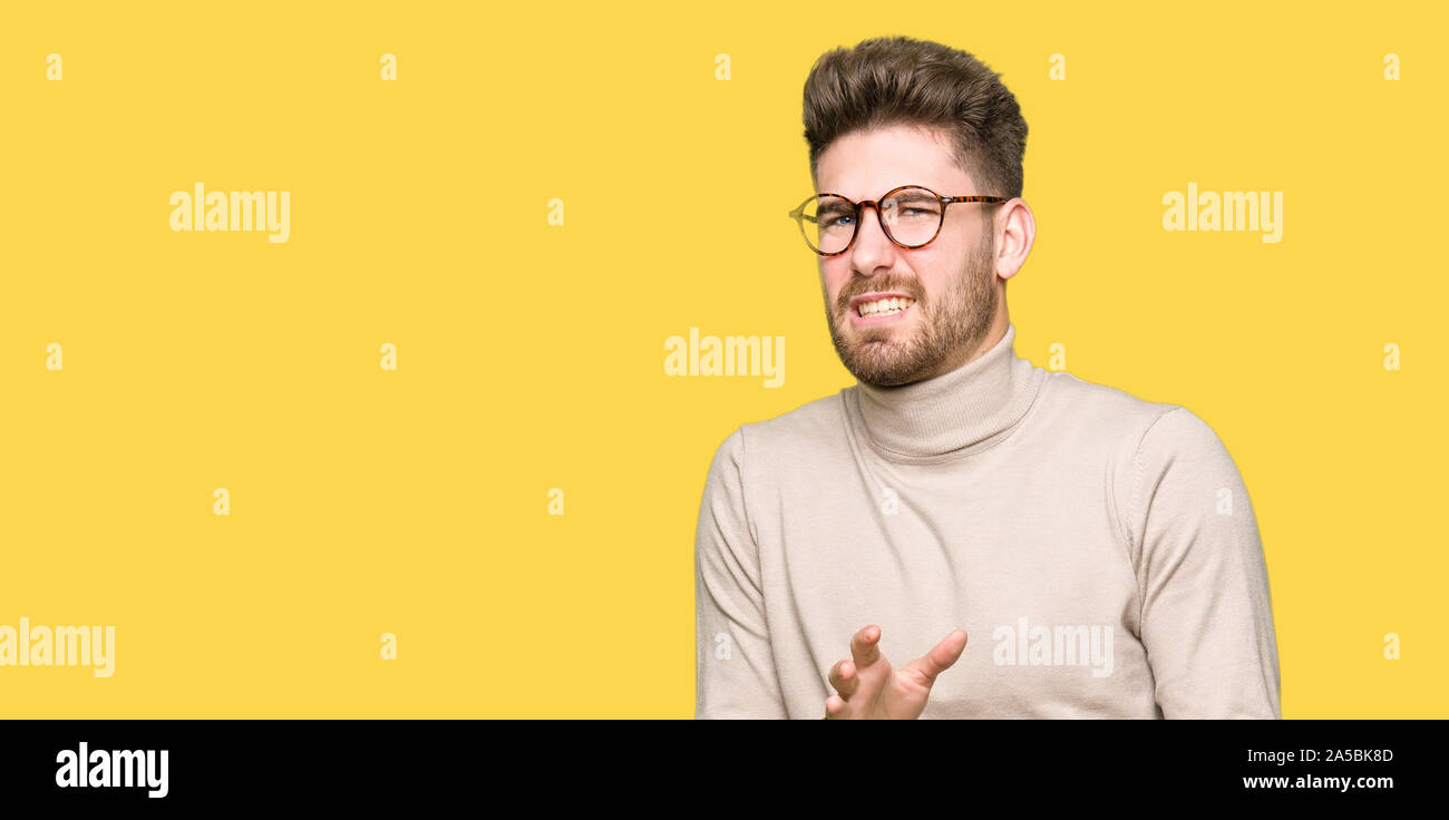 Young handsome business man wearing glasses disgusted expression ...