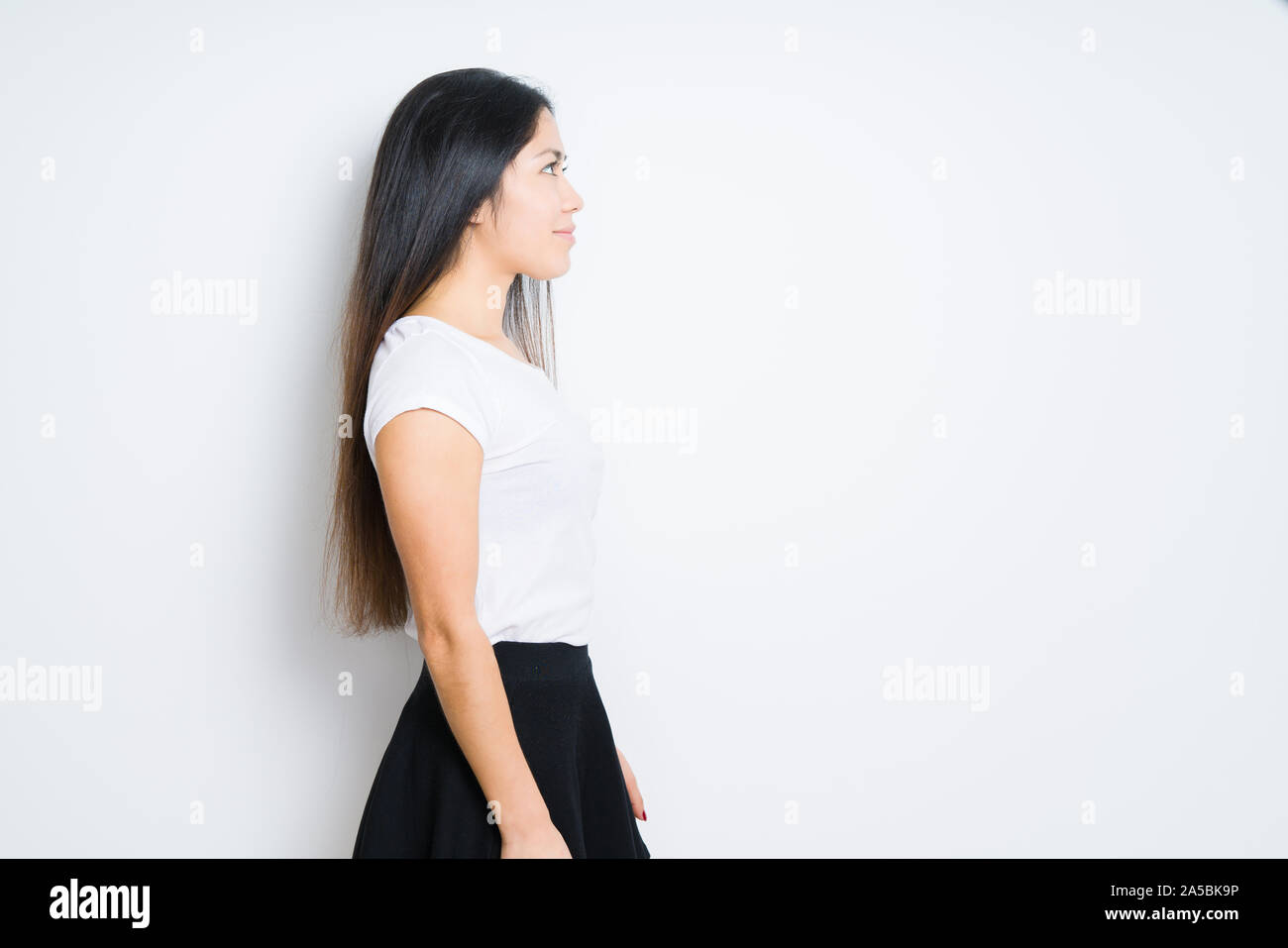 Beautiful brunette woman over isolated background looking to side ...