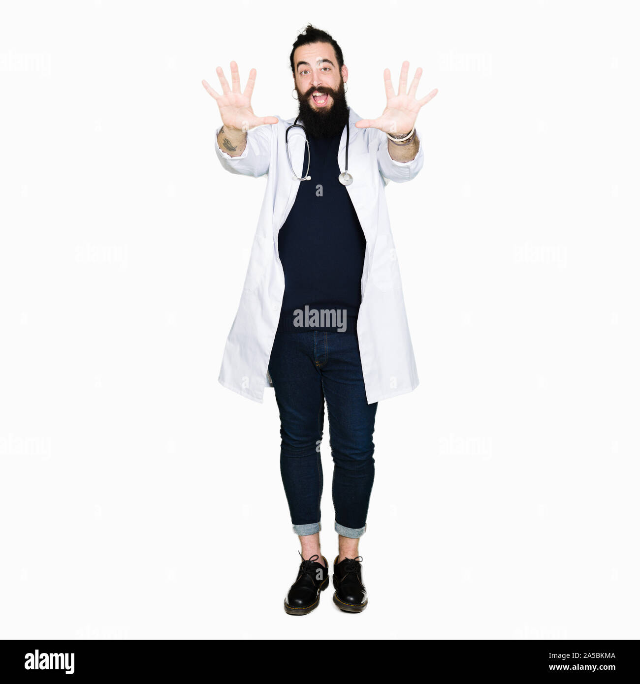 Doctor with long hair wearing medical coat and stethoscope showing and ...