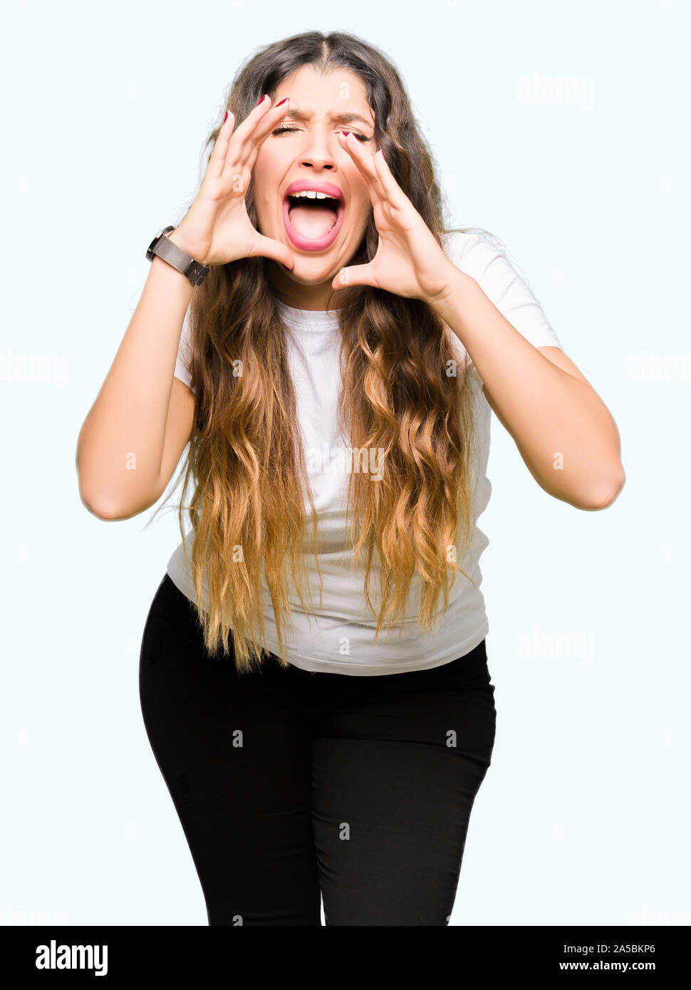 Young beautiful woman wearing casual white t-shirt Shouting angry out ...