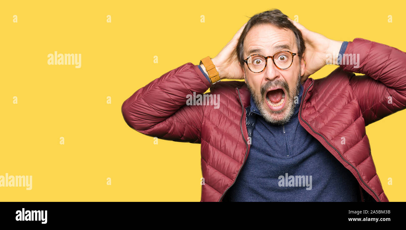 Middle age handsome man wearing glasses and winter coat Crazy and ...