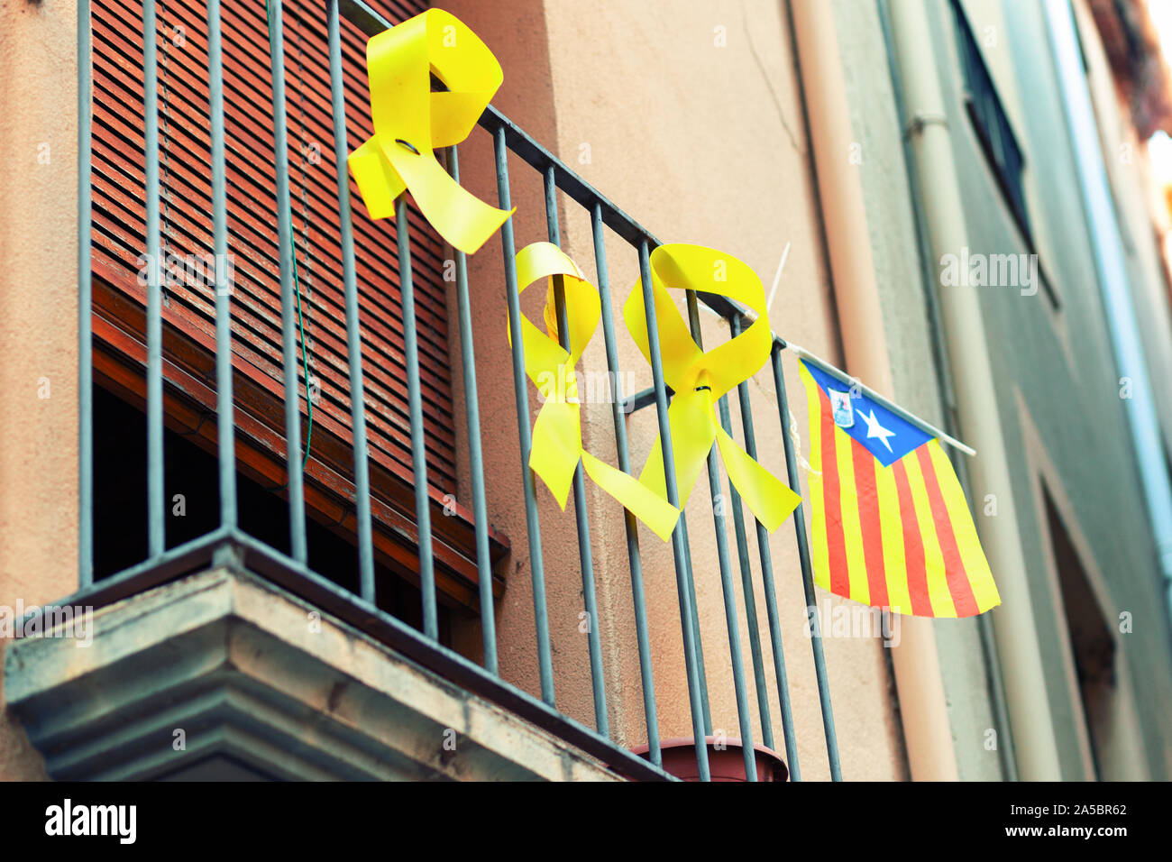Flag of Catalonia on the balcony of a building in Barcelona. Symbol of ...