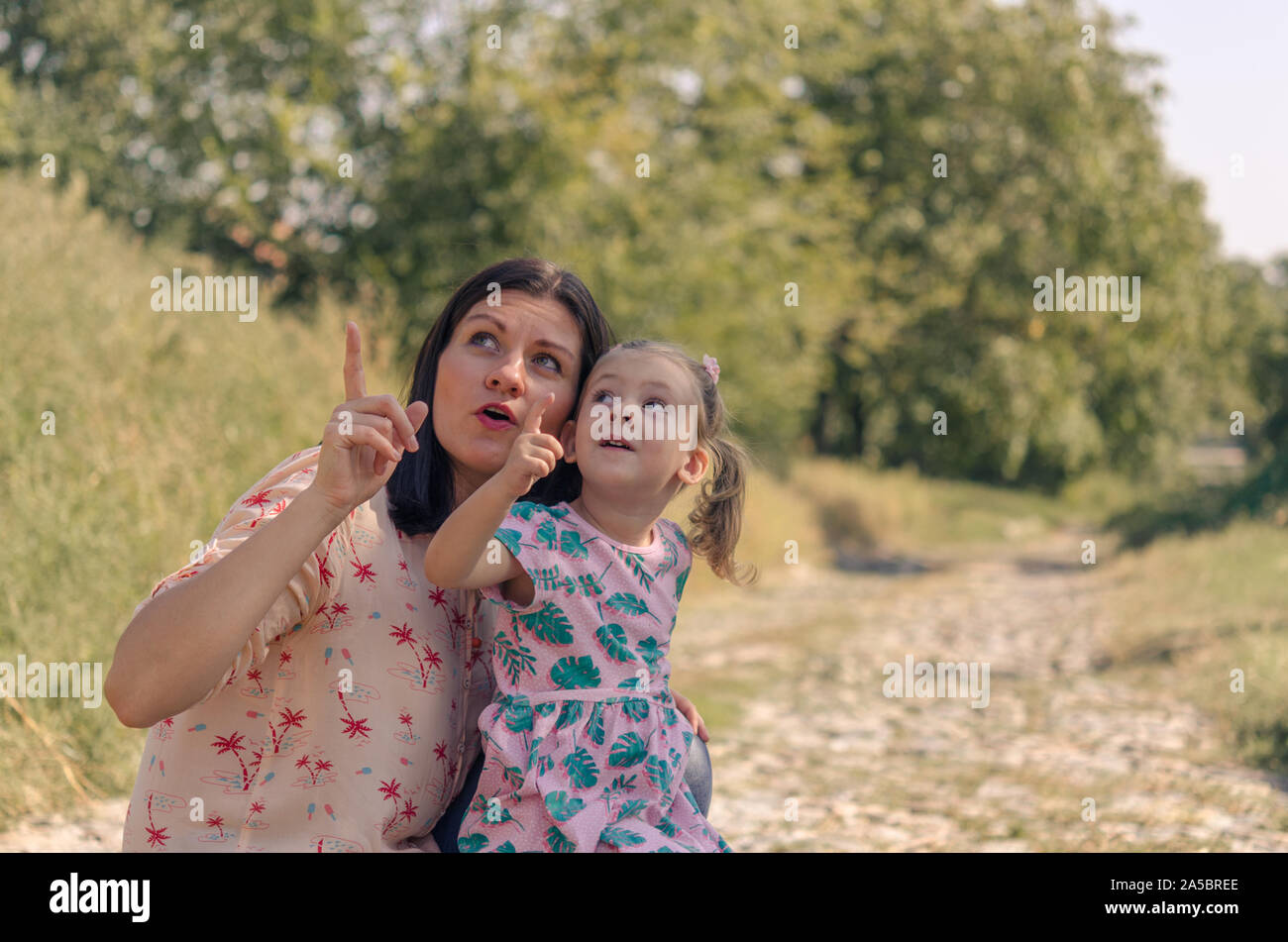Adorable girls laughing at outdoor. Photo of cheerful caucasians mother ...