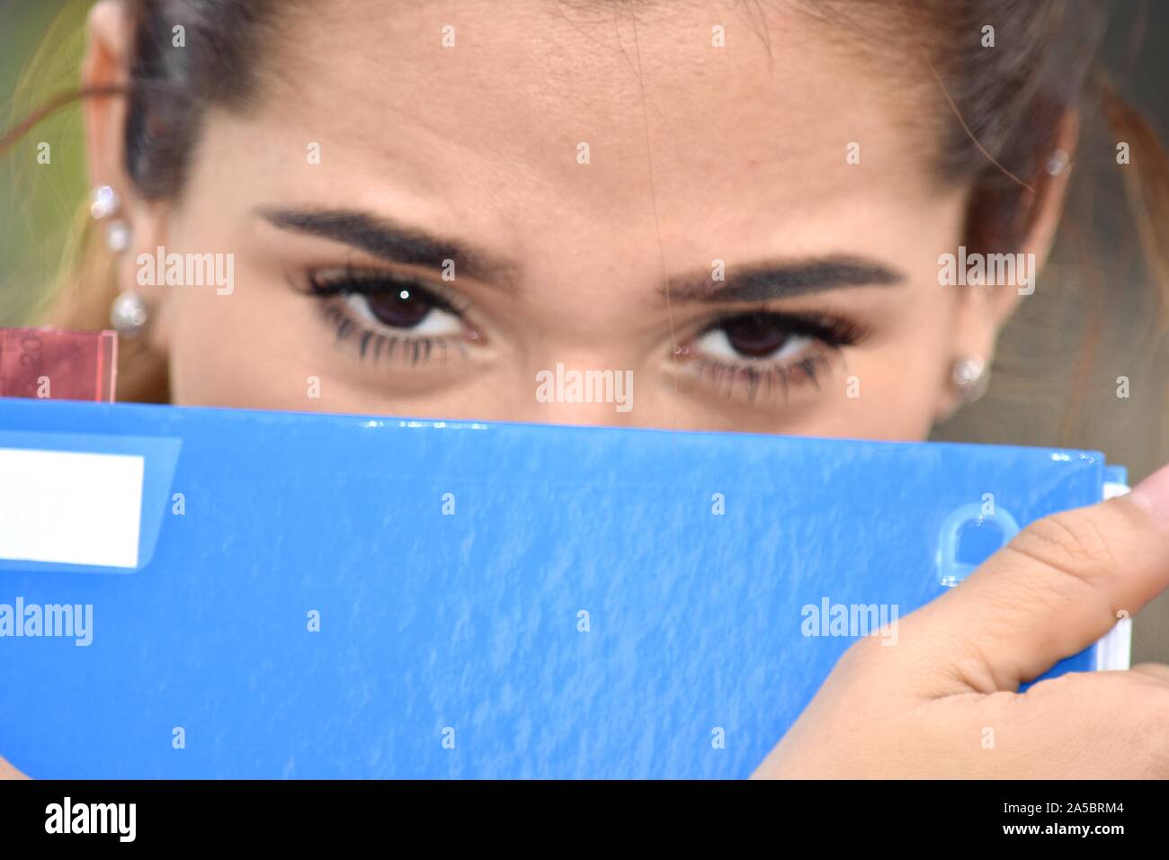Fearful Female Student With Notebooks Stock Photo - Alamy