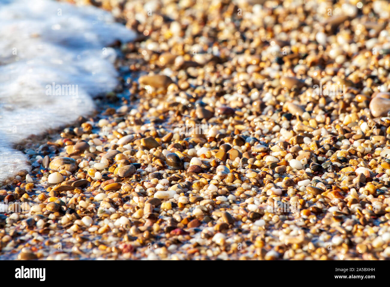 sea pebbles colored granite on the beach background stones. The shore ...