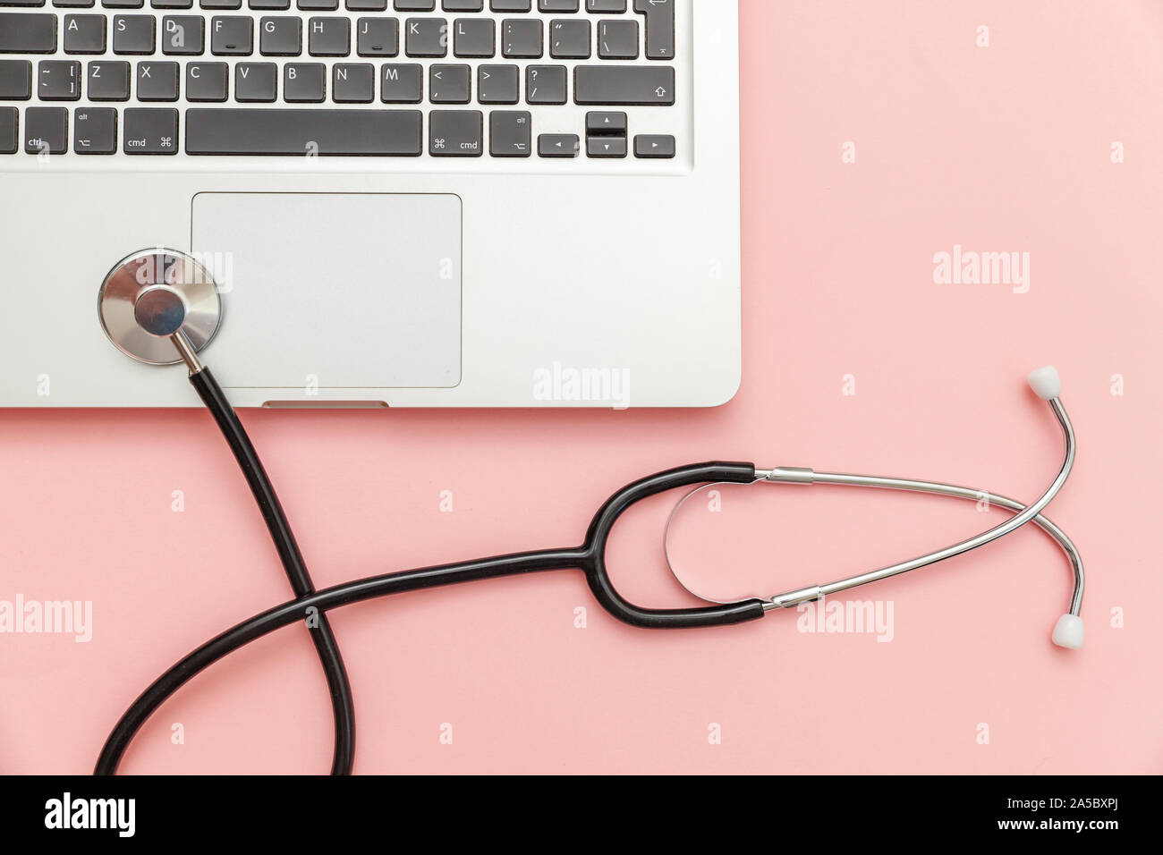 Stethoscope keyboard laptop computer isolated on pink background ...