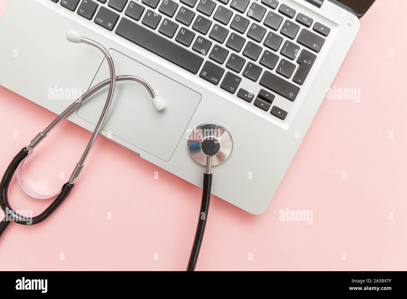 Stethoscope keyboard laptop computer isolated on pink background ...