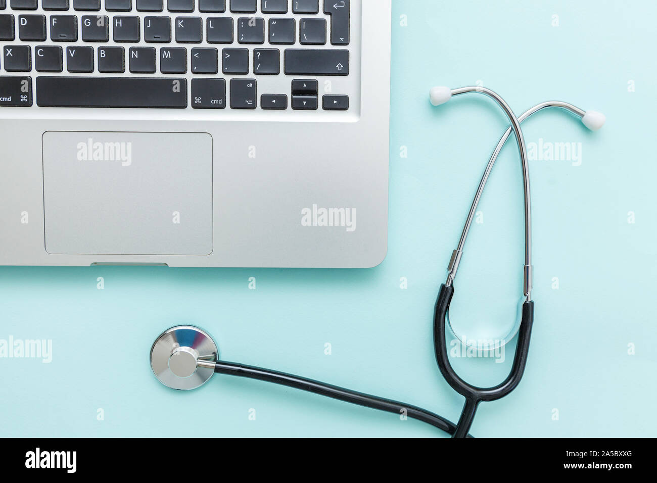 Stethoscope keyboard laptop computer isolated on blue background ...