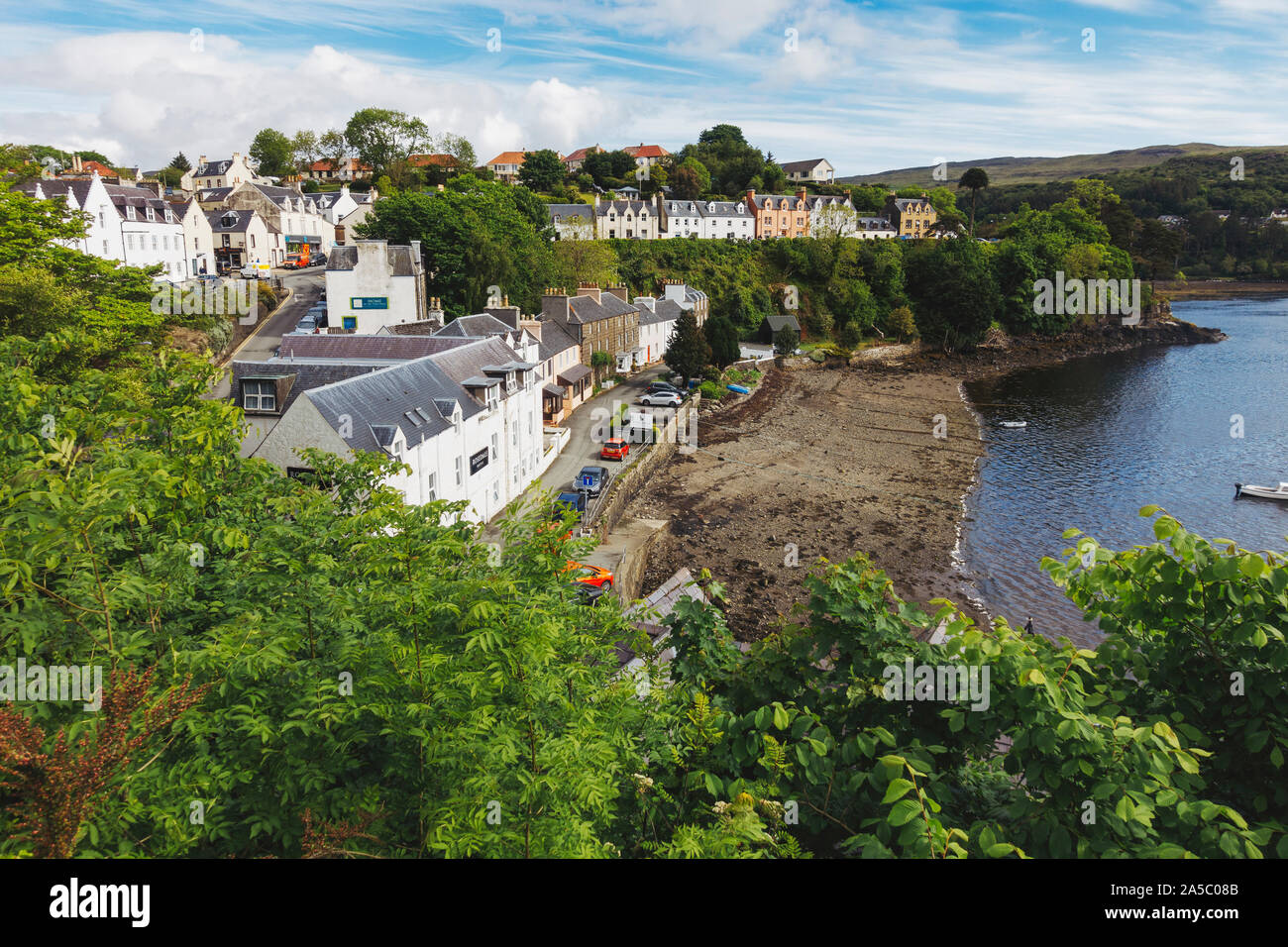 Peering over tree tops at the brightly coloured houses of Portree, from ...
