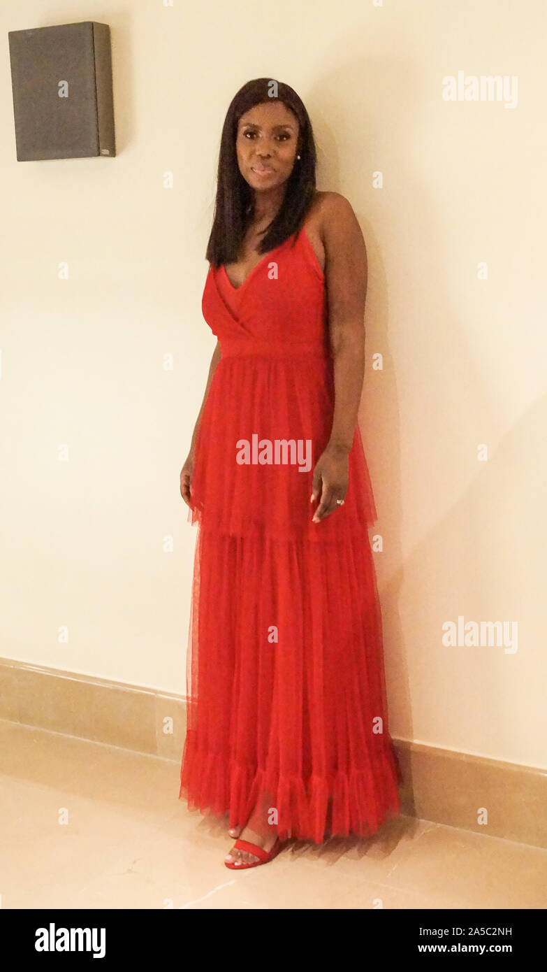 London, UK. 19 October 2019. Newsreader Claudia-Liza Armah in the red ...