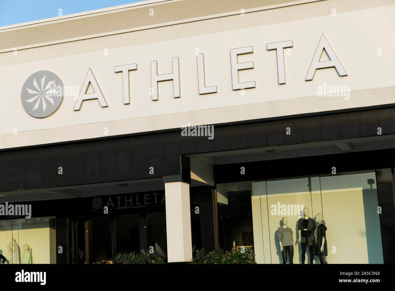 A logo sign outside of a Athleta retail store location in Greensboro ...