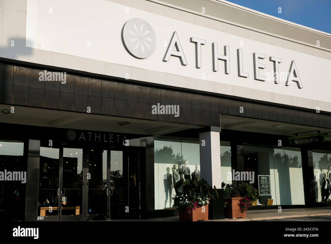 A logo sign outside of a Athleta retail store location in Greensboro ...