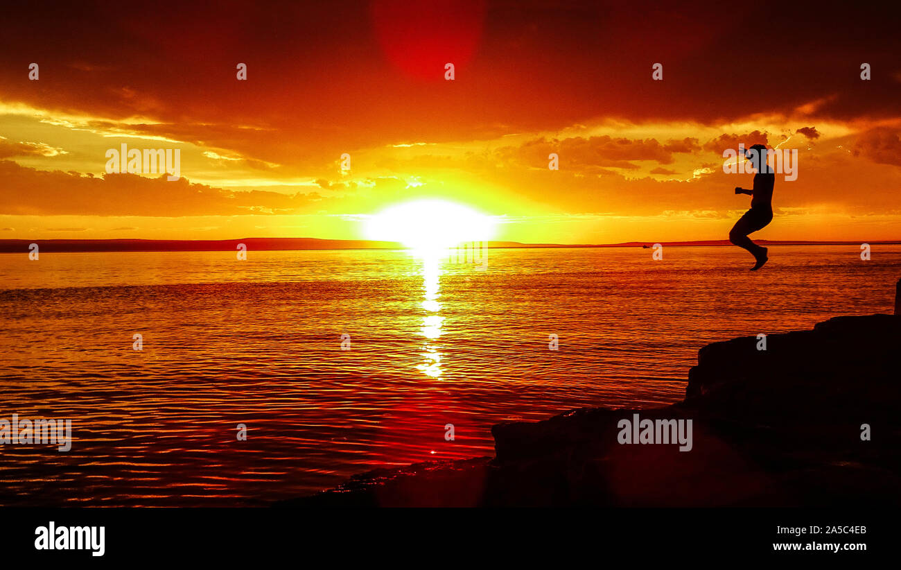 Cliff Jumping Into Ocean Sunset High Resolution Stock Photography and ...