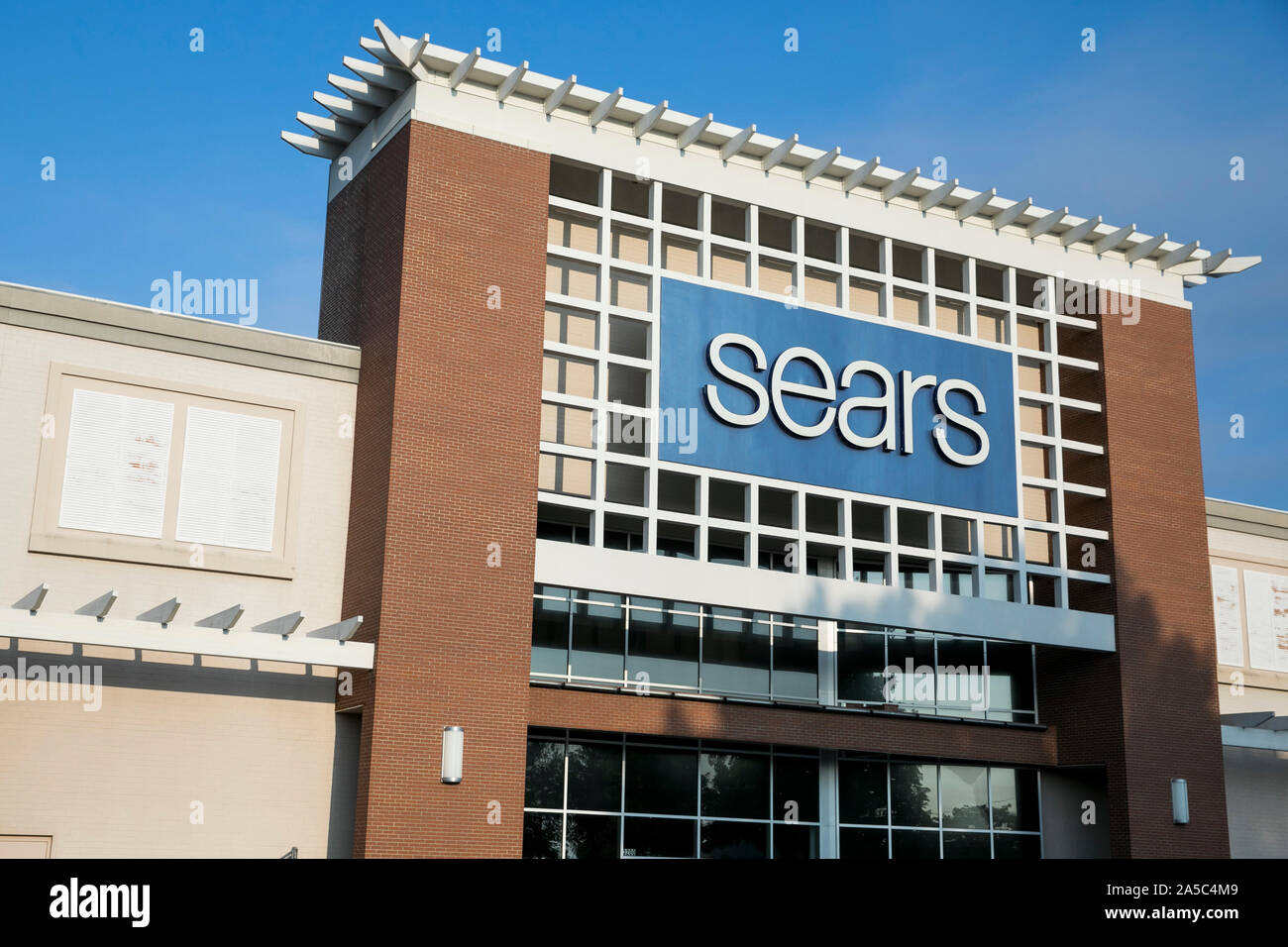 A logo sign outside of a Sears retail store location in Greensboro ...