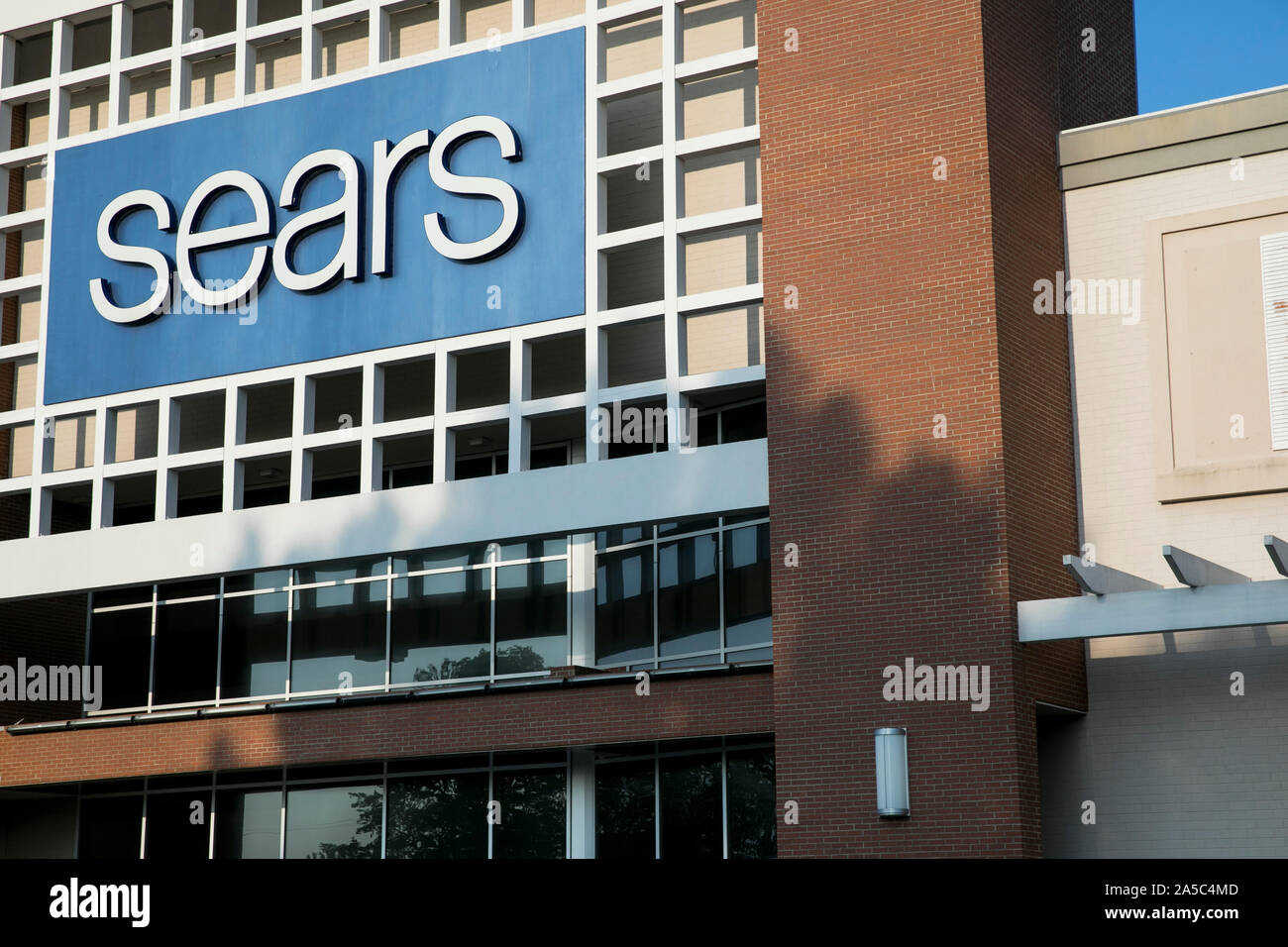 A logo sign outside of a Sears retail store location in Greensboro ...
