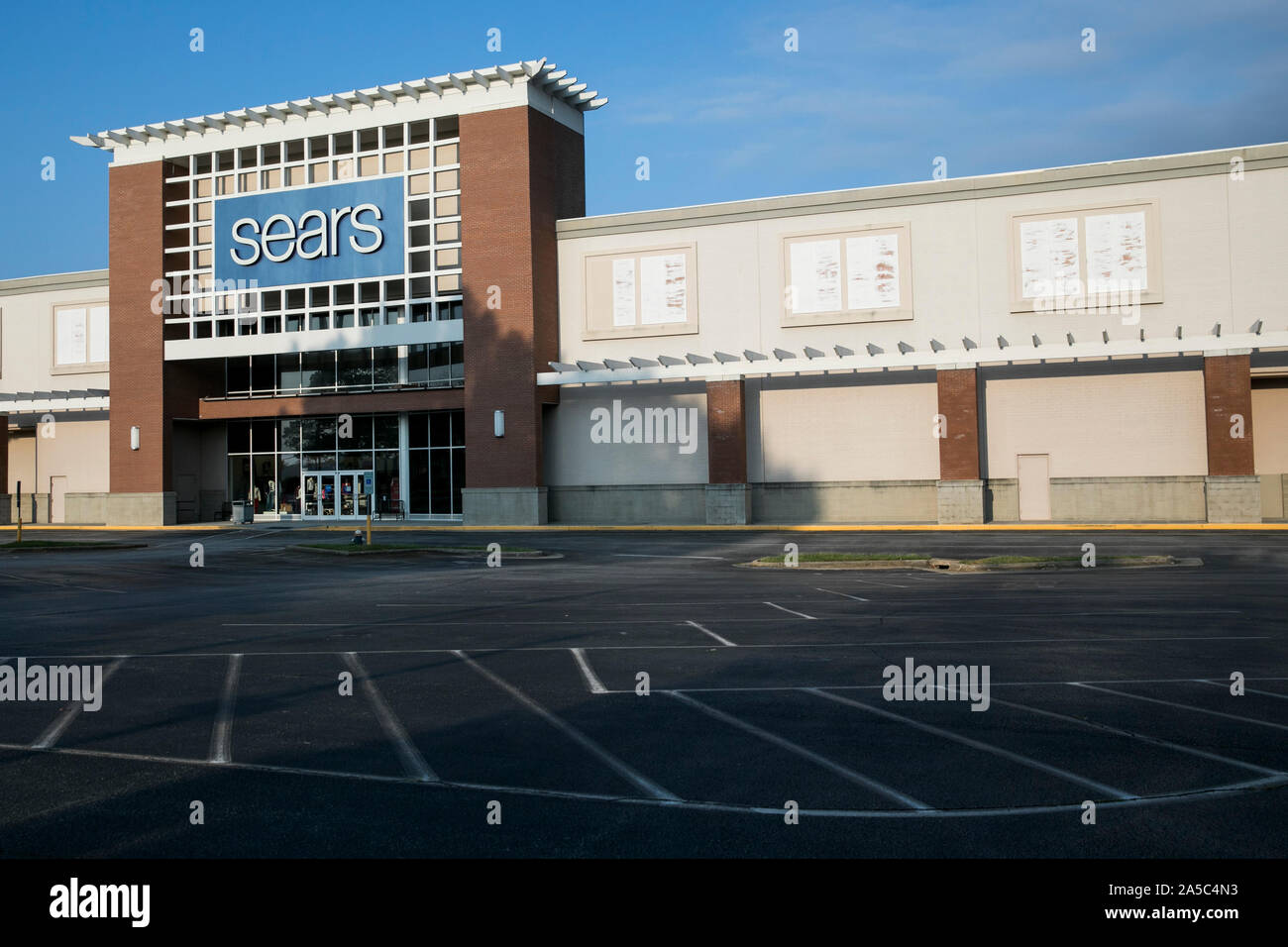 A logo sign outside of a Sears retail store location in Greensboro ...