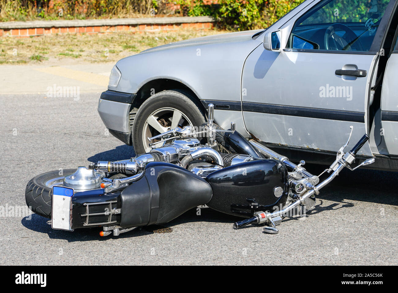 traffic accident, motorcycle collision with a car on city street Stock ...