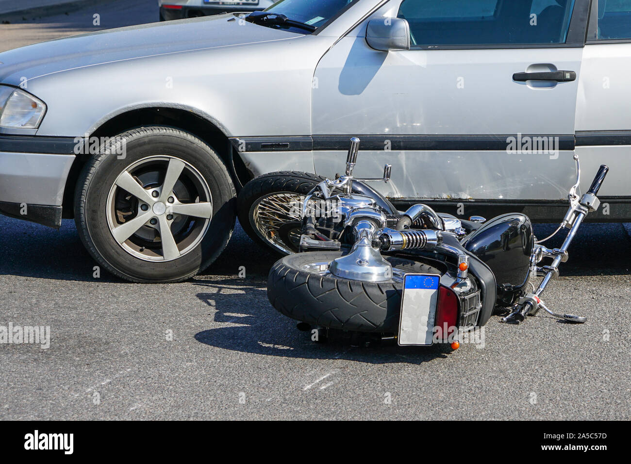 traffic accident, motorcycle collision with a car on city street Stock ...