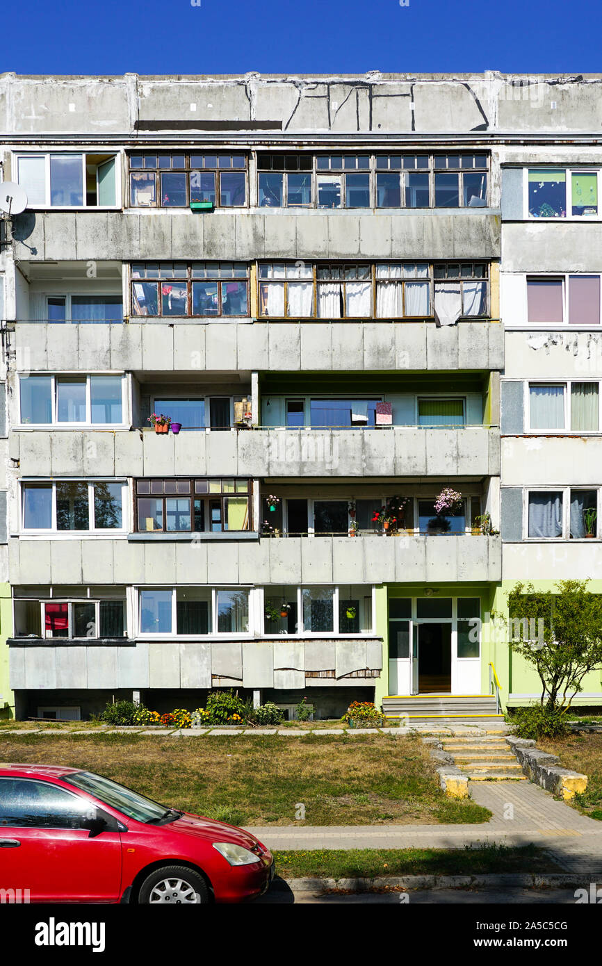 poor looking suburban block of flats against a blue sky Stock Photo - Alamy