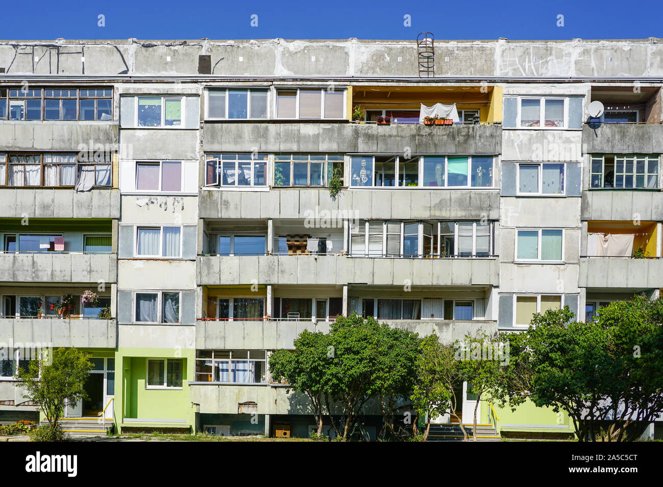 poor looking suburban block of flats against a blue sky Stock Photo - Alamy