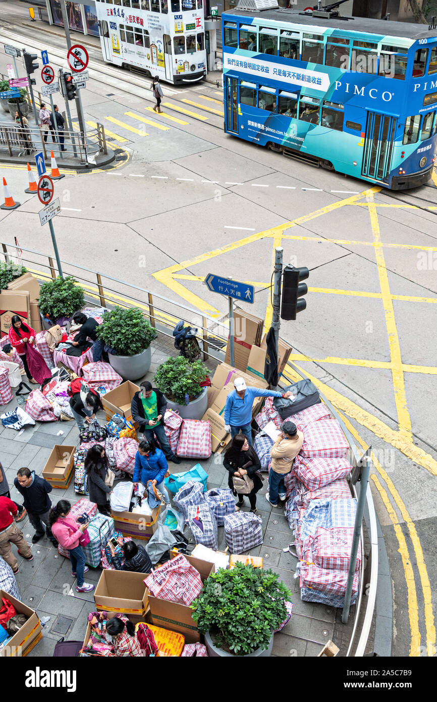 Filipino domestic workers gather on their day-off and prepare shipments ...