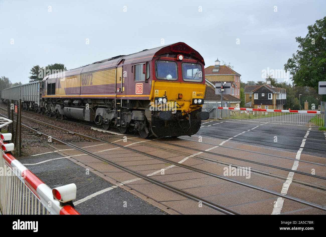 DB Cargo Class 66 Locomotive 66172 passes the level crossing at March ...