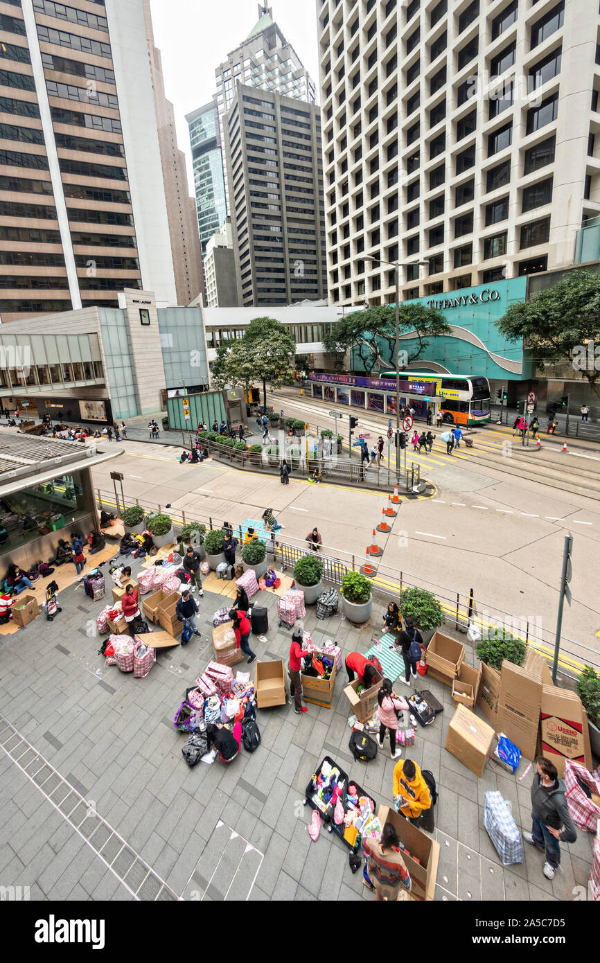 Filipino domestic workers gather on their day-off and prepare shipments ...