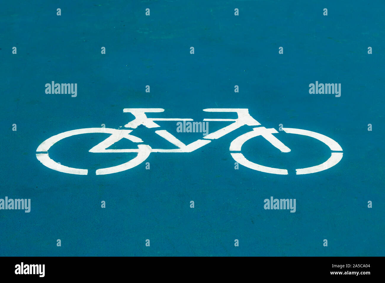 White bike sign on blue bike path background Stock Photo - Alamy